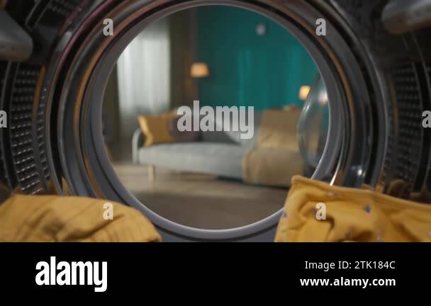 Washing machine full of colorful clothes inside the drum with opened ...