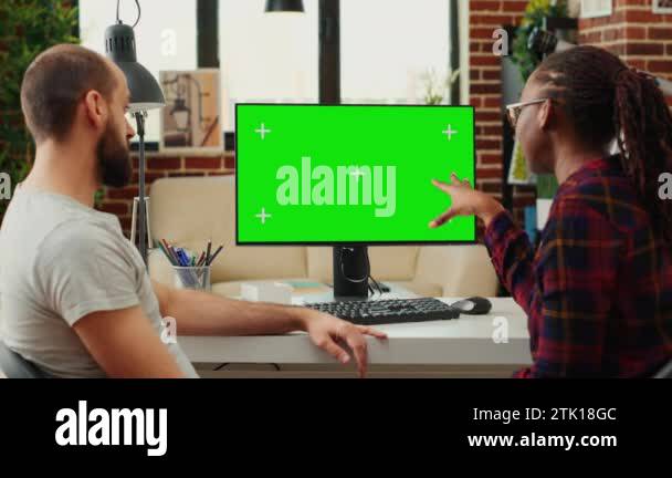 Diverse people working with greenscreen monitor on computer, analyzing ...