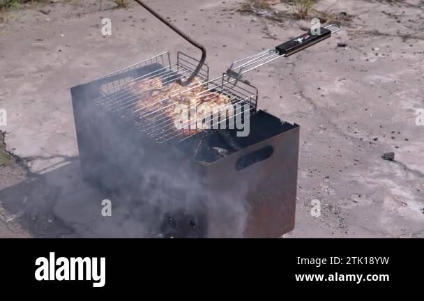 Male Stirring Black Briquettes with Smoking Coals in a Brazier with a ...