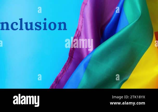4k zoom in out Rainbow flag with text INCLUSION message. Rainbow lgbtq ...