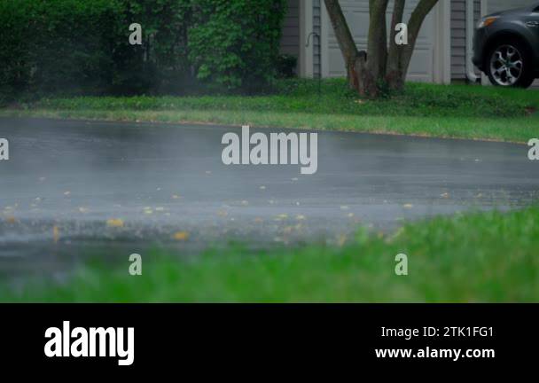 Fog after rain, heavy rain water drops falling into big puddle on ...
