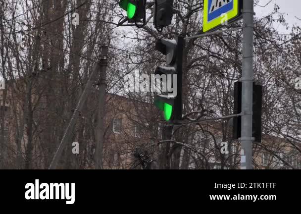 Close-up of a green traffic light at a pedestrian crossing. Two traffic ...