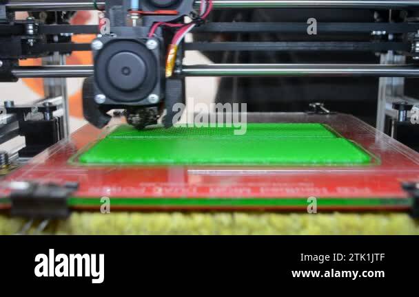 3D printer printing prototype of toy from molten plastic. Process of ...