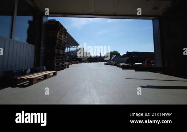 Open air warehouse with euro pallets, packed material, metal corners ...