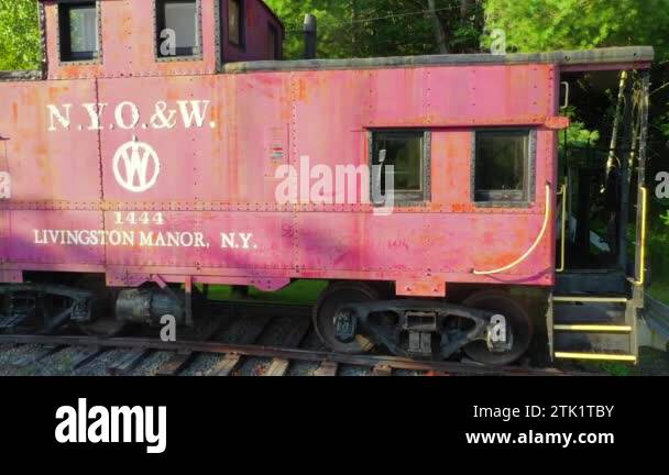 This video shows a view of a red caboose. A caboose is a railroad car ...