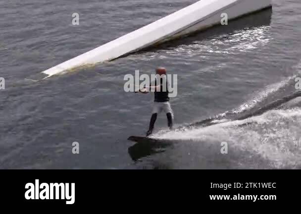Wakeboarder ride on cable wakeboard in park, outdoor extreme on water ...