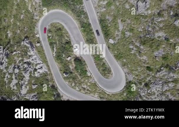 Rotating top view of a curved rural road with a few cars. - Paradisiac ...