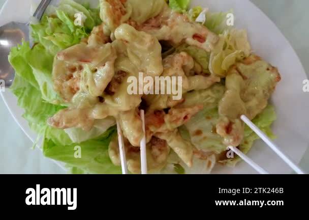 Eating crispy fried big prawn shimp with creamy fusion mayonnaise ...