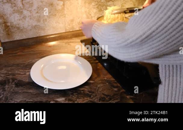 Man in sweater puting homemade spaghetti with bolognese sauce made of ...