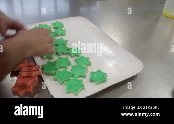 baker slicing red violet yellow and green star cloud and heart shaped ...
