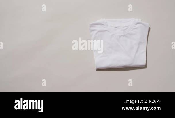 Video of stack of folded white t shirts with copy space on white ...