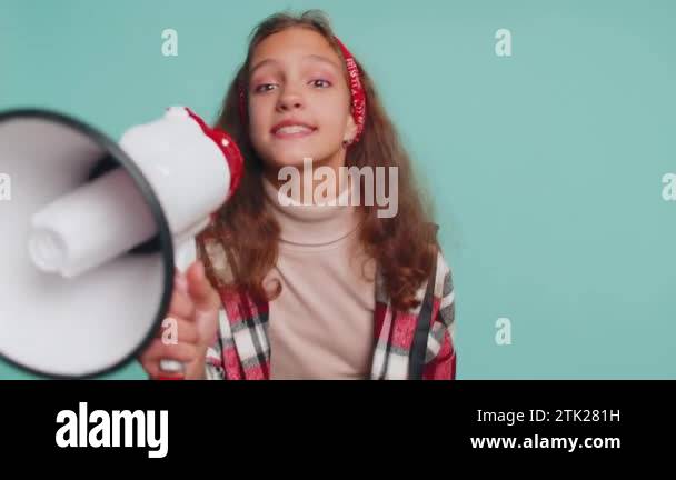 Hurry up. Young teenager child girl kid talking with megaphone ...