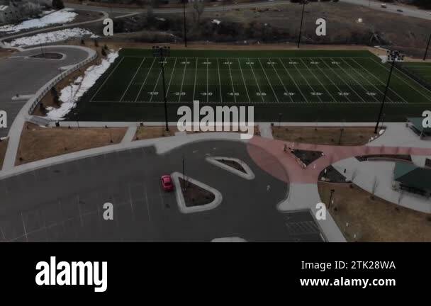 Football Field and Park Next to Busy Road with Traffic Aerial Drone ...