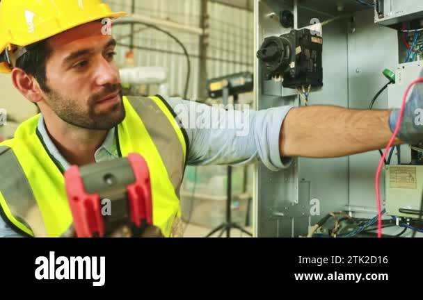 Male electronic technician caucasian checking electrical control system ...