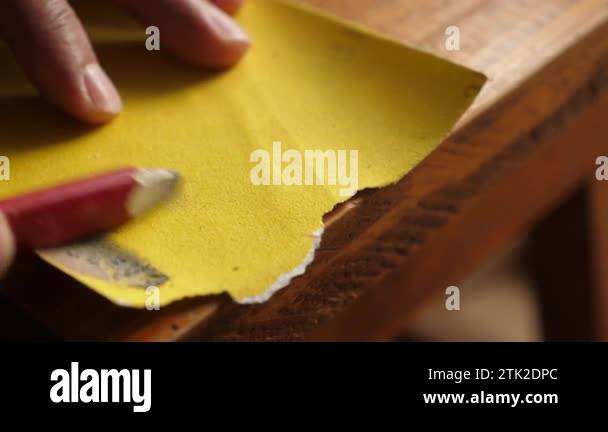 A carpenter's pencil is sharpened with sandpaper. Preparation for the ...