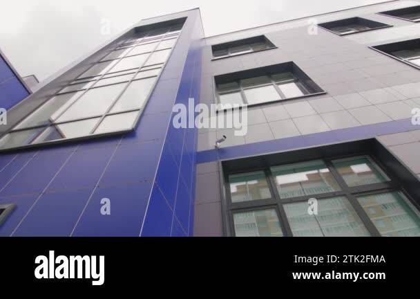 CCTV camera hanging in corner of modern school building. Device ...