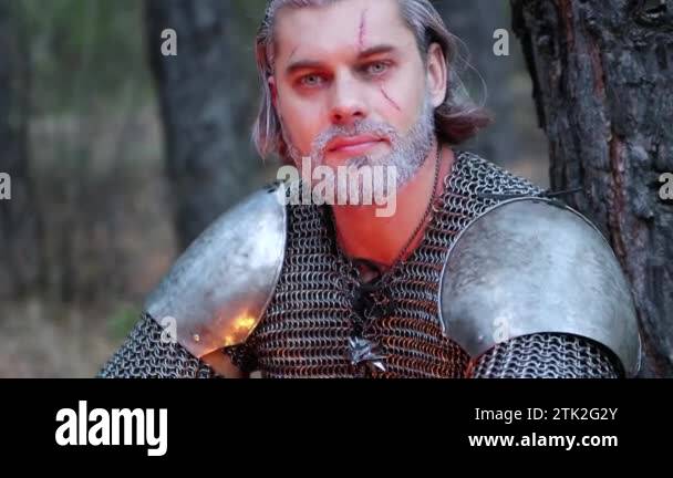 Portrait of a medieval warrior with gray hair and a scar on his face in ...