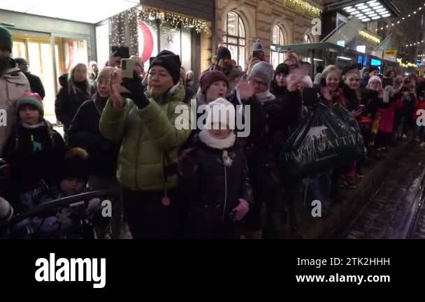 HELSINKI, FINLAND - NOVEMBER 19, 2022: Many adults and children greet ...