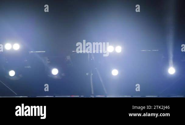 flashing and rotating light beams from stage lights on a construction ...