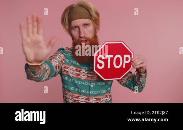 No stop. Serious hippie man say No, hold inscription text red No stop ...