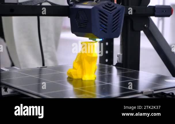 3D printer printing prototype of toy from molten plastic. Process of ...