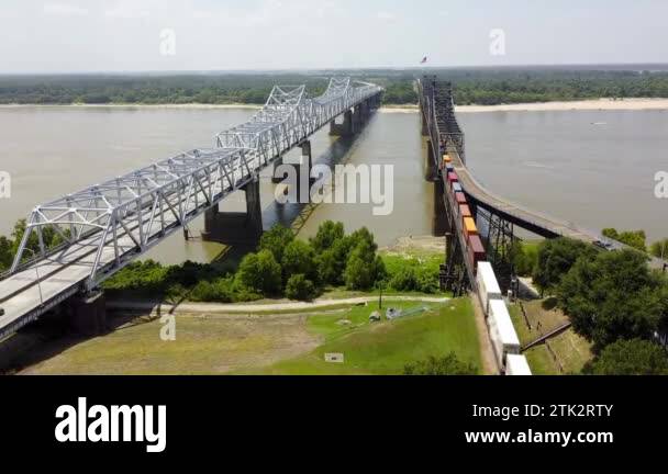 Freight train, car traffic, speeding river boat over Vicksburg Bridge ...