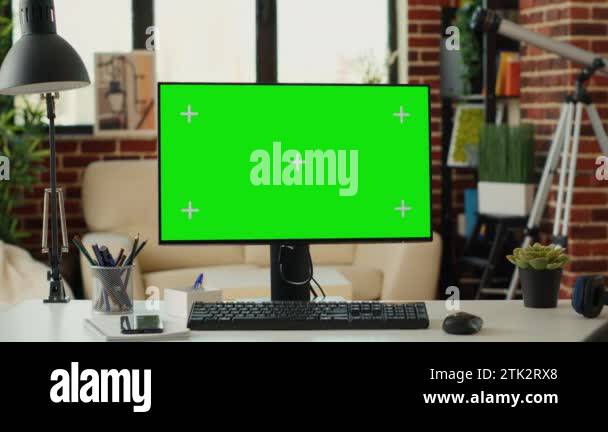 Empty desk with computer and greenscreen on monitor, showing chroma key ...