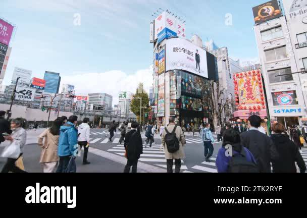 Tokyo, Japan - Dec 2, 2022: Crowded people walk cross road, car traffic ...