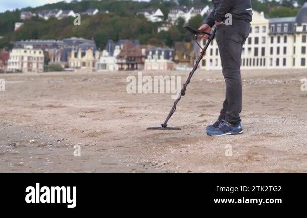 Metal Detecting At The Beach. Man Searching For Hidden Metals On Sandy ...