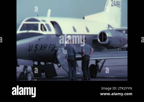 US Air Force officers talking near a parked VIP transport plane with ...