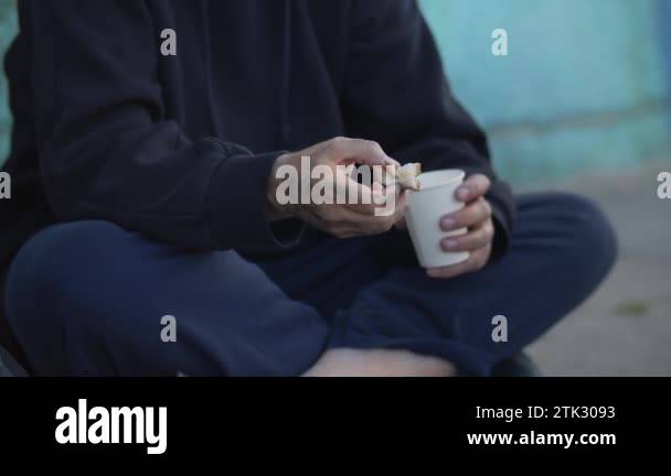 homeless poor young man sitting on the ground in the city with a Help ...