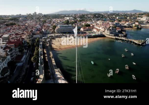Lisbon, Portugal - July 30, 2023: Aerial orbit over flag at Cascais Bay ...