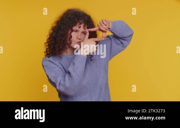 Curly haired woman photographer gesturing picture frame with hands ...