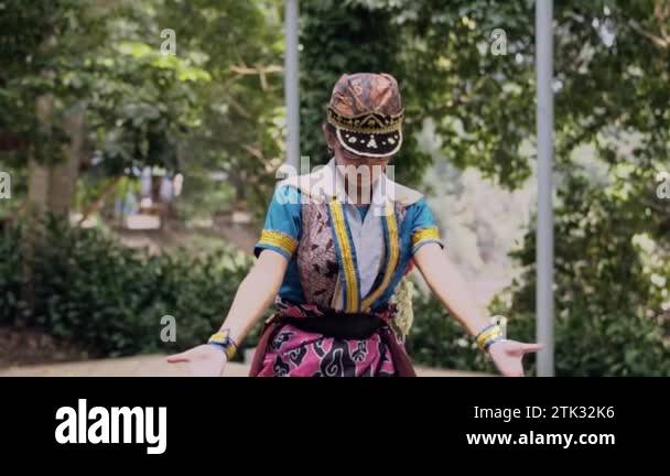 An Indonesian dancer dances a traditional dance called topeng Cirebon ...
