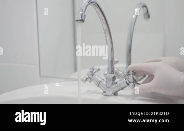 Shooting with a Person Closing a Water Tap in the Bathroom. Closing the ...