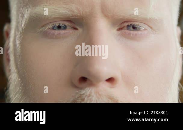 Smiling relaxed man looking at camera. Male model with discolored hair ...