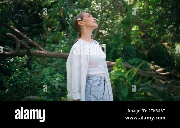 Lady looking park greenery standing sunny clearing alone close up. Carefree peaceful woman ...