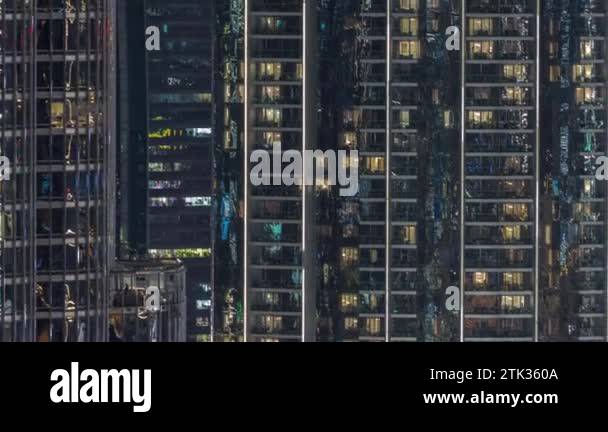 Windows lights in modern tower buildings timelapse at night. Multi ...