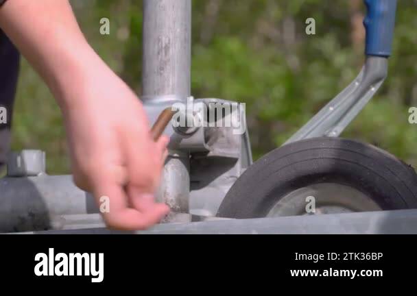 A man rotating a knob on the caravan trailer during the installation ...