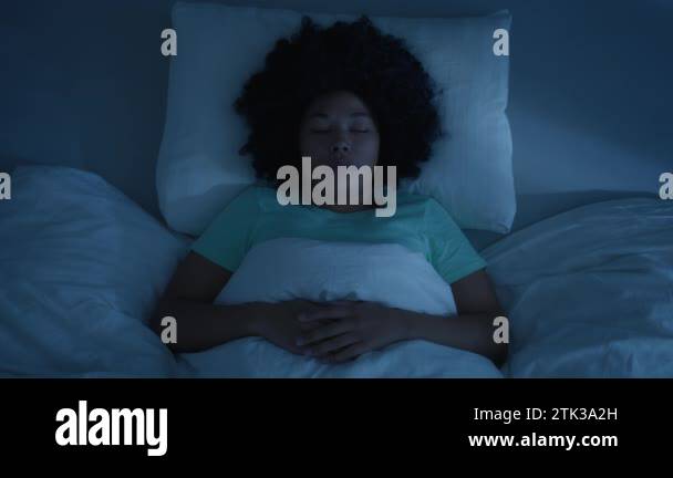 Beautiful African American woman waking up through a nightmare on dark ...