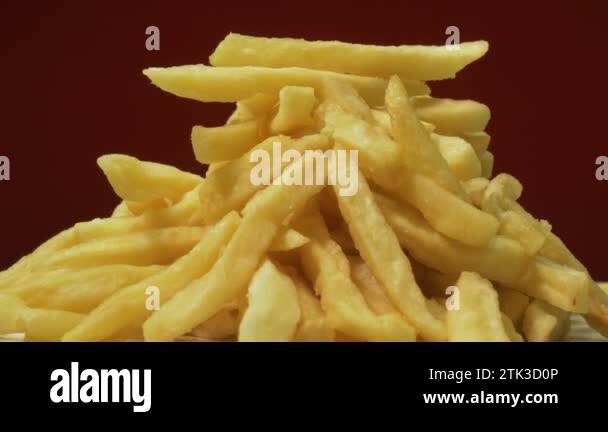 French fries on a red background rotates, appetizing potatoes with a ...