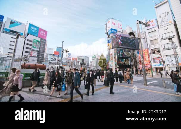 Tokyo, Japan - Dec 2, 2022: Crowded people walk cross road, car traffic ...