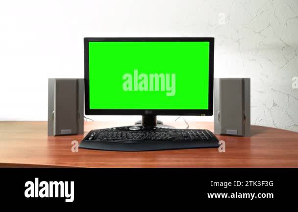 Computer green screen monitor is standing on a desk in an office ...