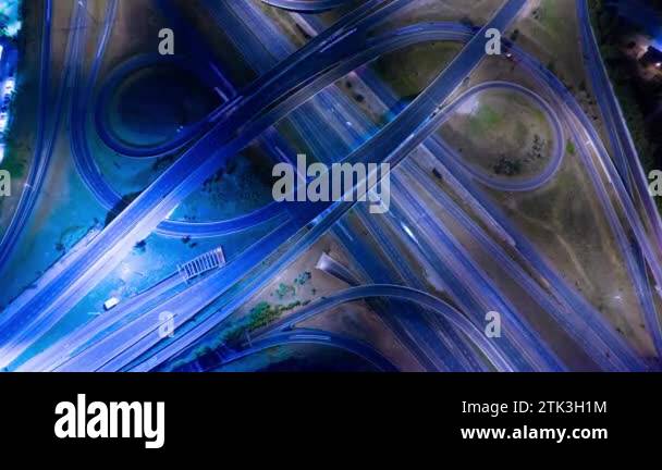 Highway aerial view night time lapse. Speed ramps, expressway lanes ...