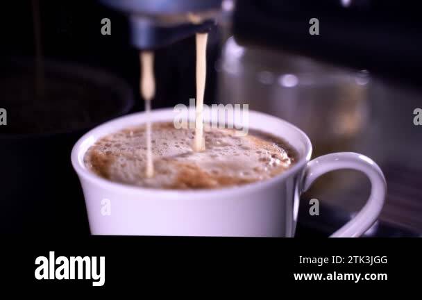 close-up of Coffee foam. espresso crema comes out of the fully ...