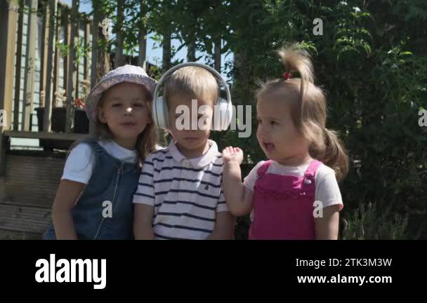 Portrait of Cute Little Three Children With Headphones Listening to ...