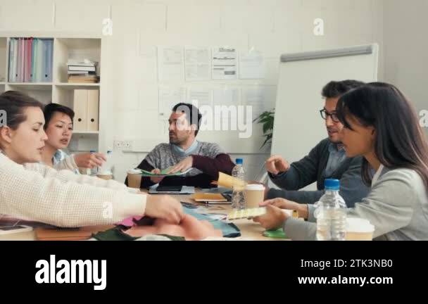 Creative, fashion and team planning a project with paperwork, color ...