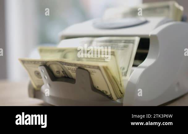 Side angle view banknote counting machine with male Caucasian hand ...