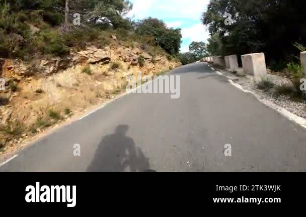 Cyclist athlete descending on road bike on serpentine road. Road ...