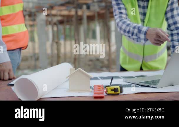 Engineers team use laptop and check the blueprint on site. Contractor ...